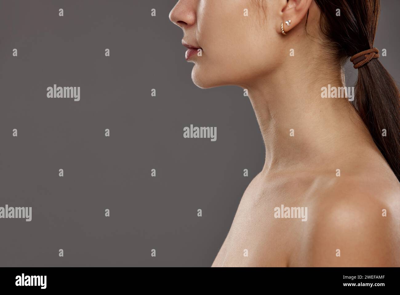 Double chin. Cropped image of female face, profile against studio ...