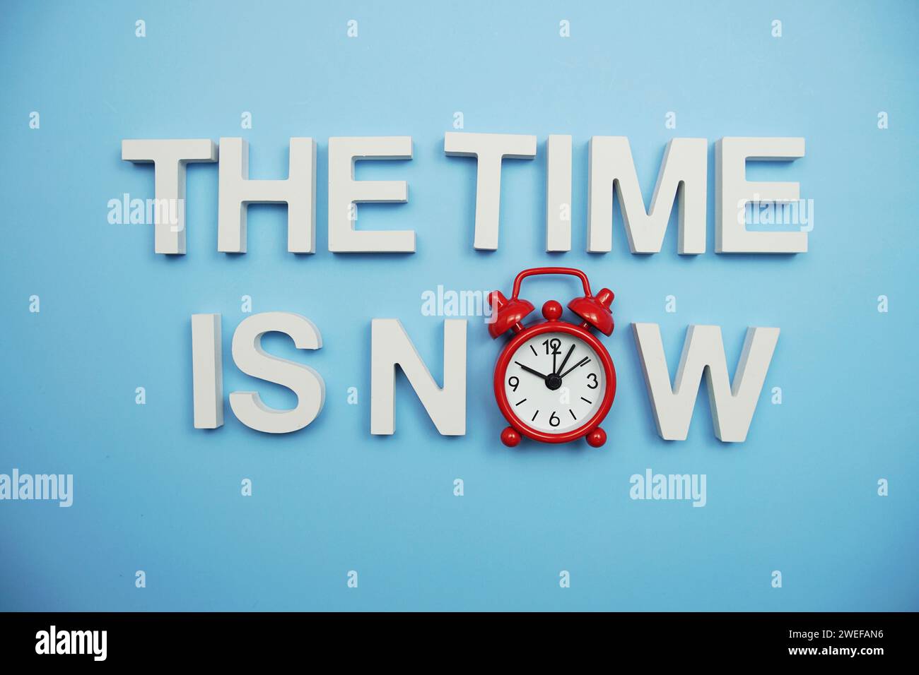The Time is Now alphabet letters on blue background Stock Photo - Alamy