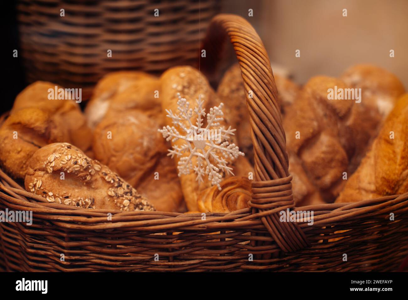 Fresh baked multigrain bread in a wicker basket in a baked goods store ...