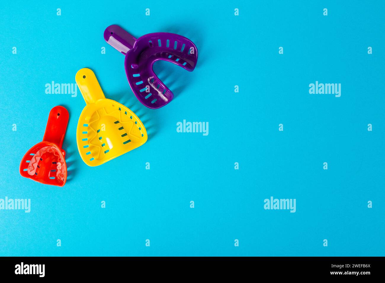 Multi-colored dental spoons for taking an impression of the dental jaw ...