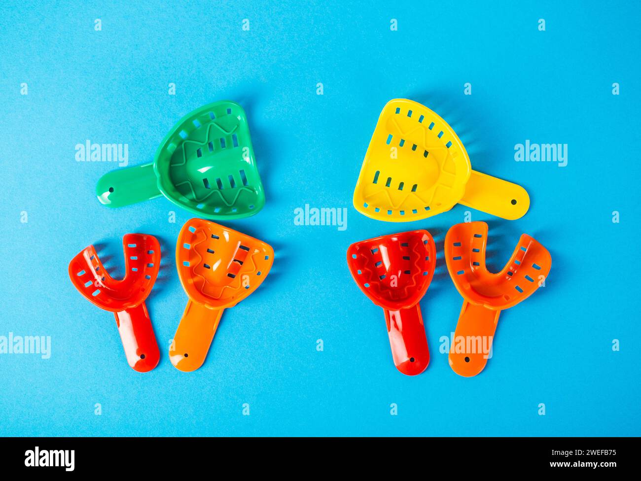 Multi-colored dental spoons for taking an impression of the dental jaw ...
