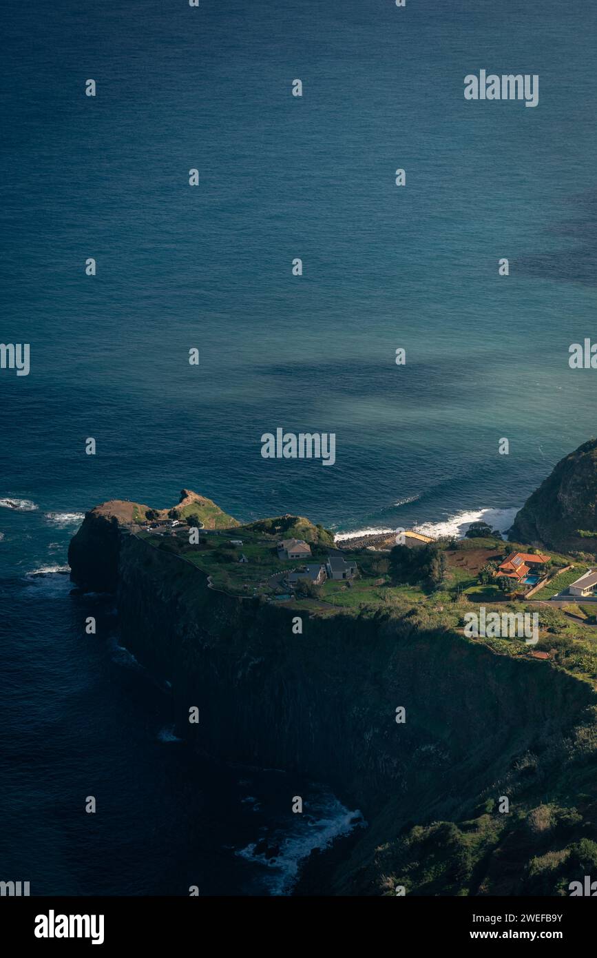 A stunning landscape featuring a rocky cliff overlooking a secluded ...