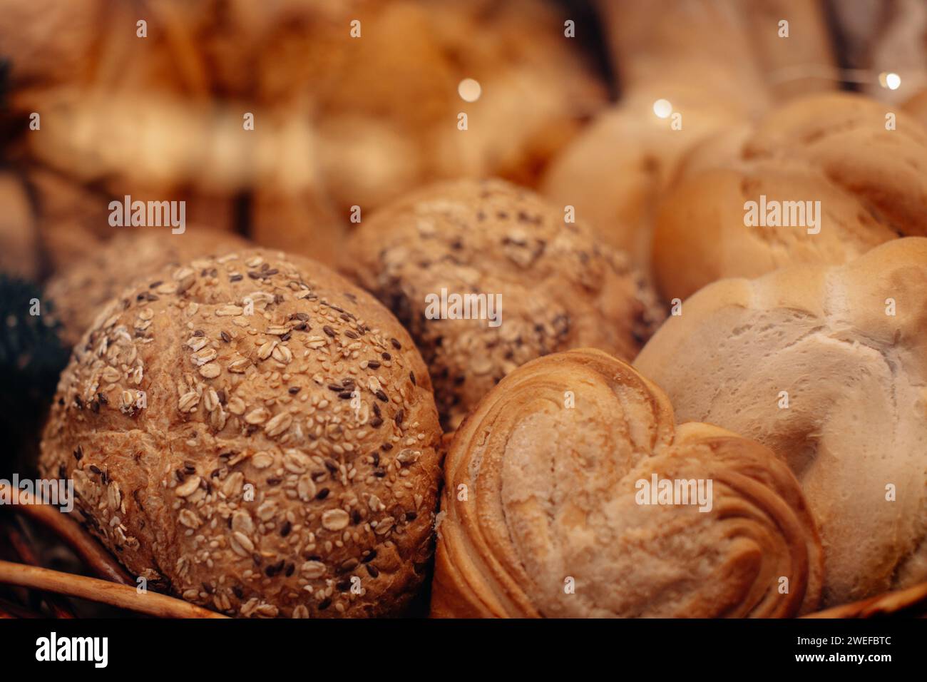 Fresh baked multigrain bread in a wicker basket in a baked goods store ...