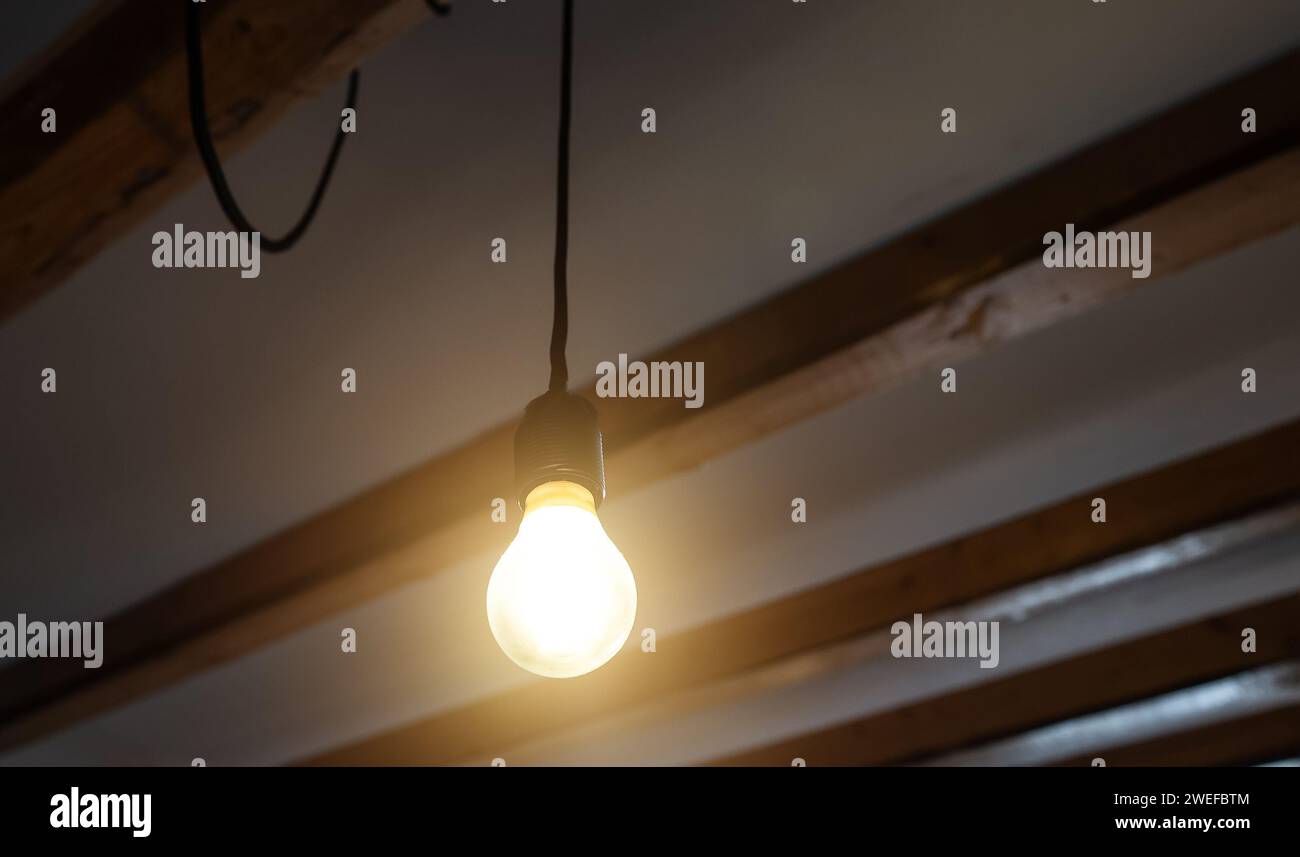 Bright incandescent light bulb illuminates hi-res stock photography and ...