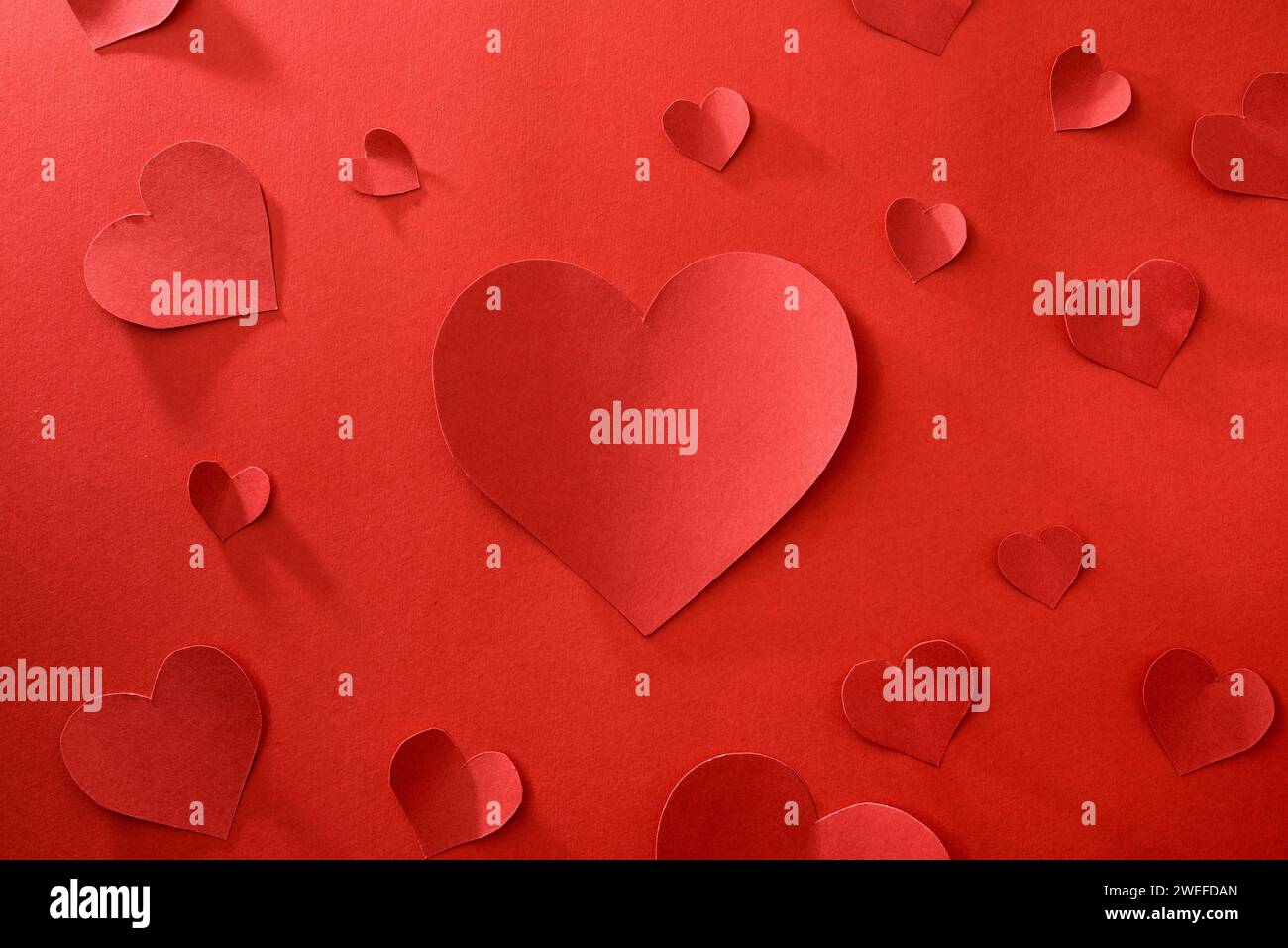 Heart cutout in the center on a red textured background with other ...