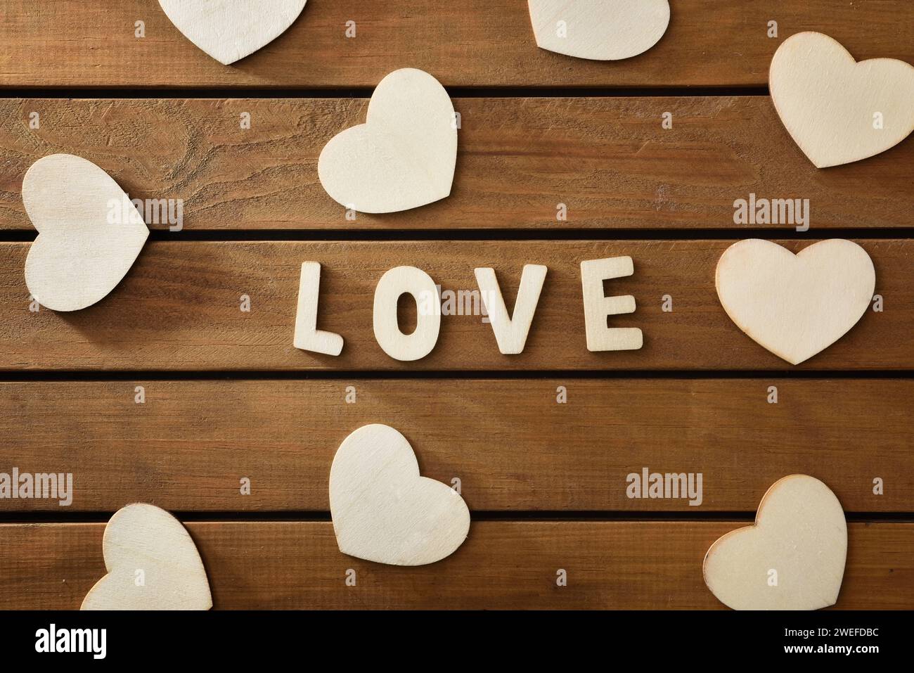 Background with wooden cutouts with letters forming word love and ...
