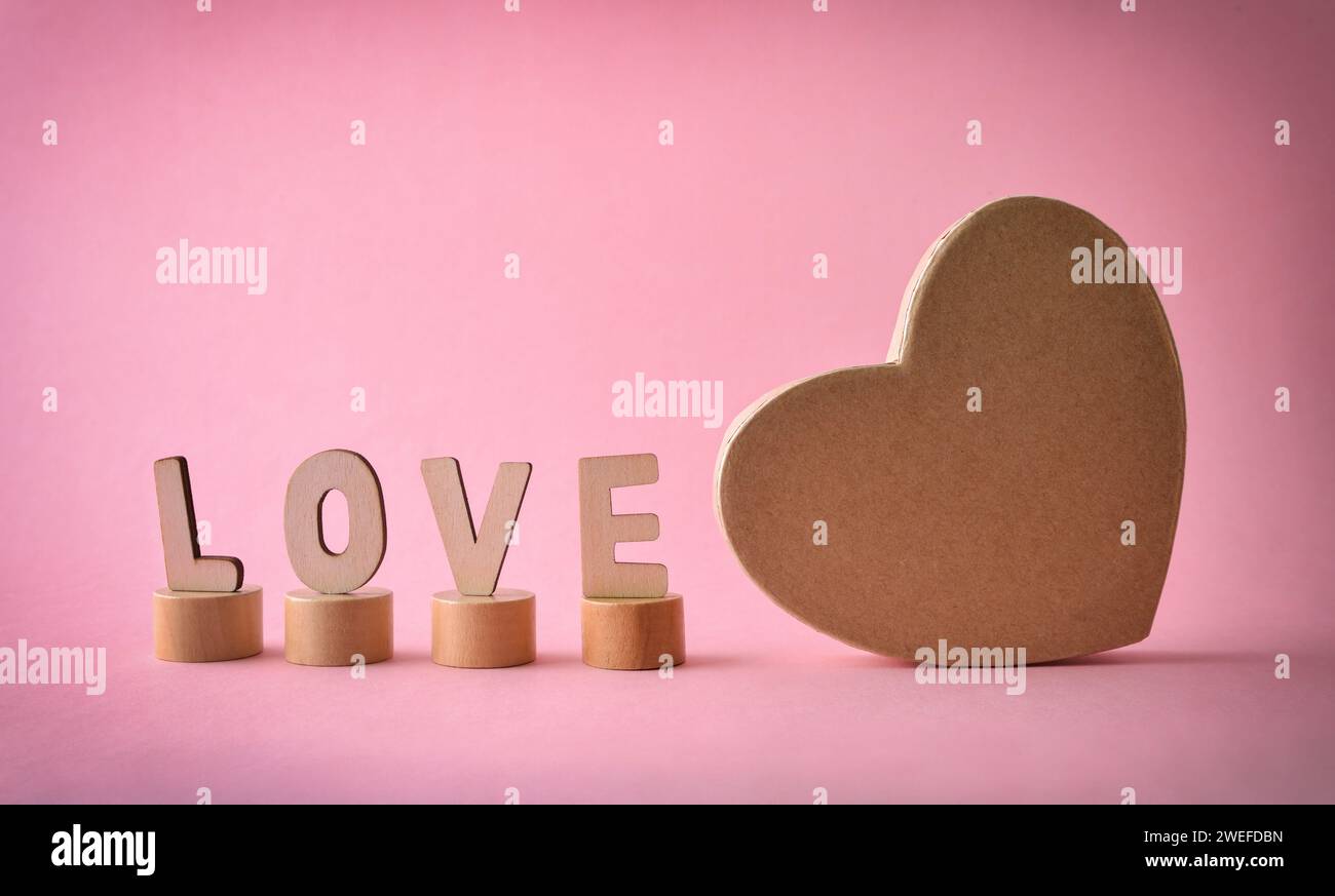 Love background with cutouts of letters forming word love on wooden ...