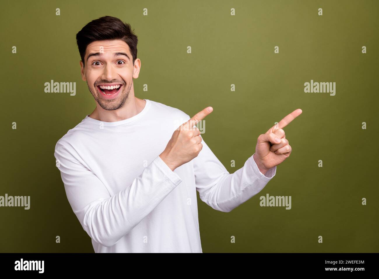 Portrait of astonished positive person indicate fingers empty space ...