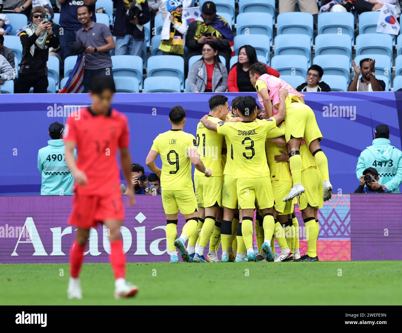 Doha. 25th Jan, 2024. Players of Malaysia celebrate scoring during the ...