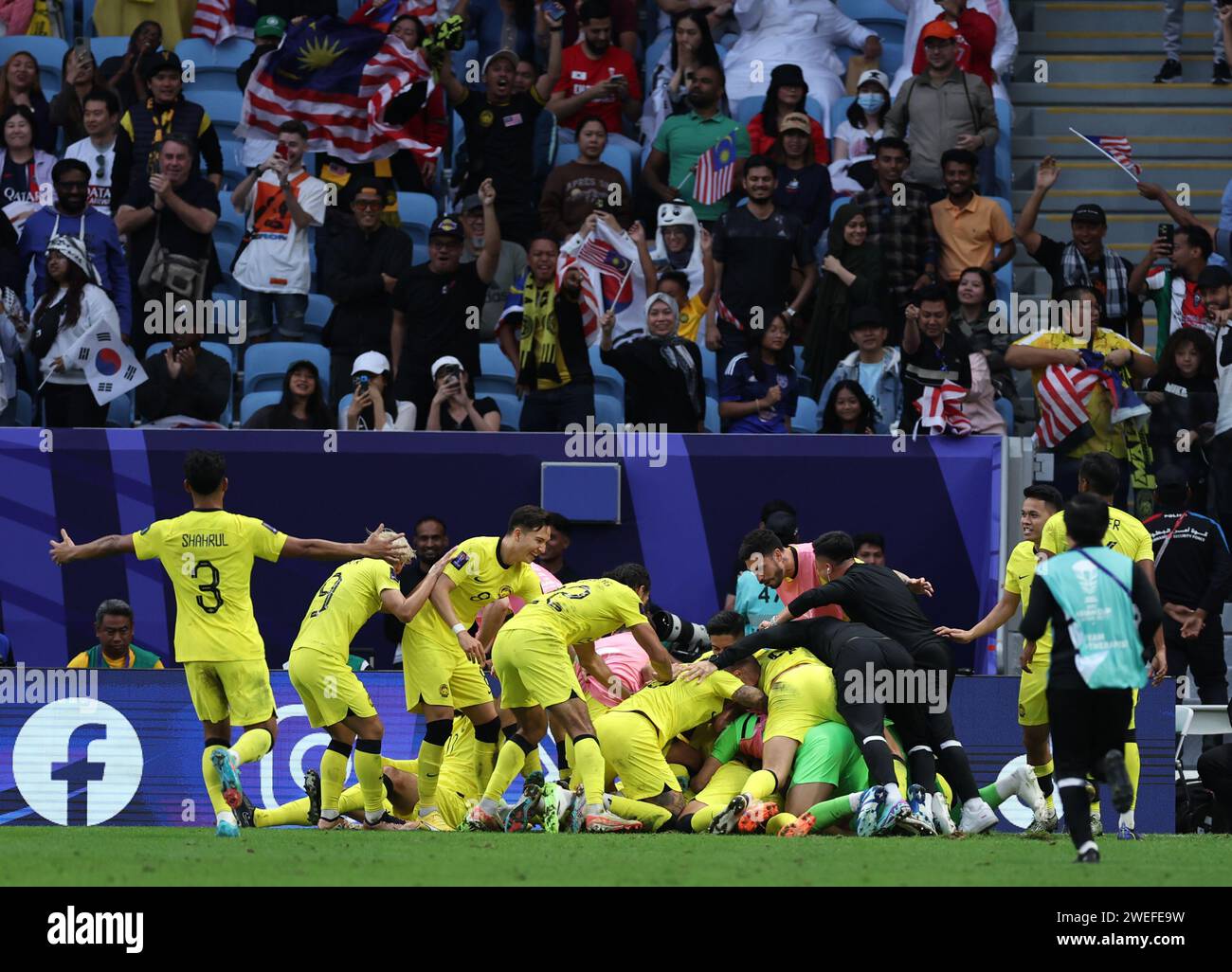 Doha. 25th Jan, 2024. Players of Malaysia celebrate scoring during the ...