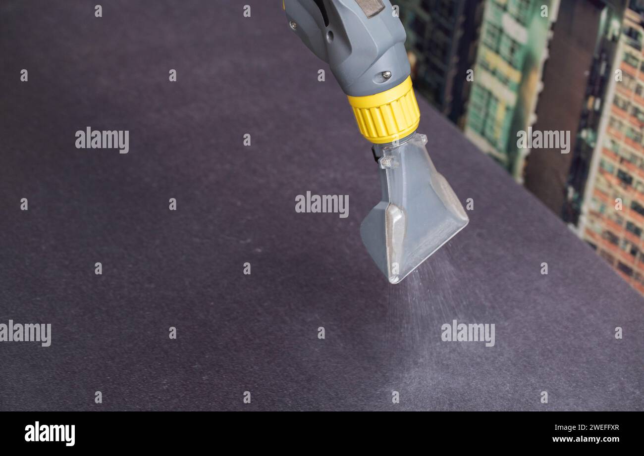 Applying a special cleaning solution to clean stains and dirt on ...