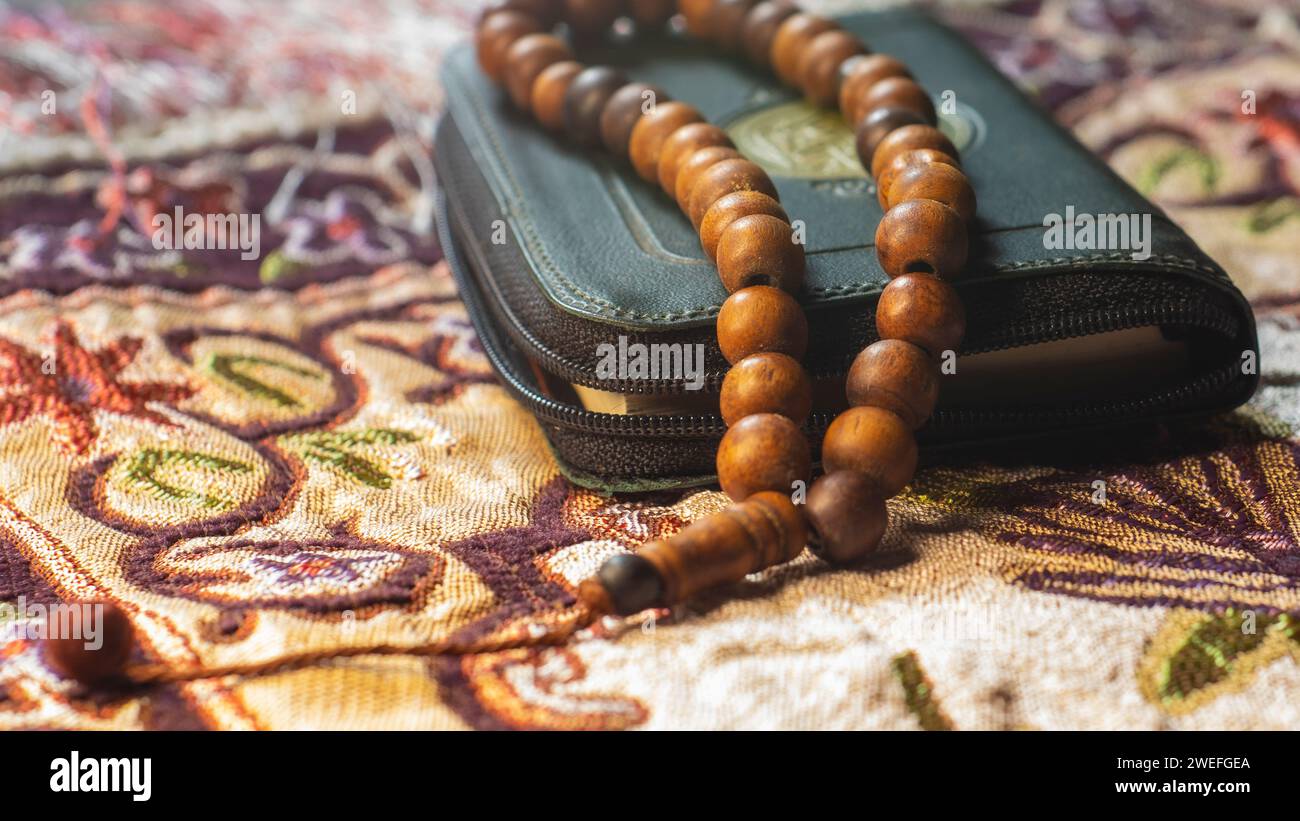 Wooden prayer beads and Holy Book for religion concept Stock Photo - Alamy