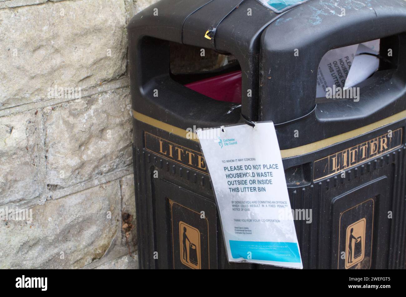 Litter bin with a notice not to place household waste inside or outside ...