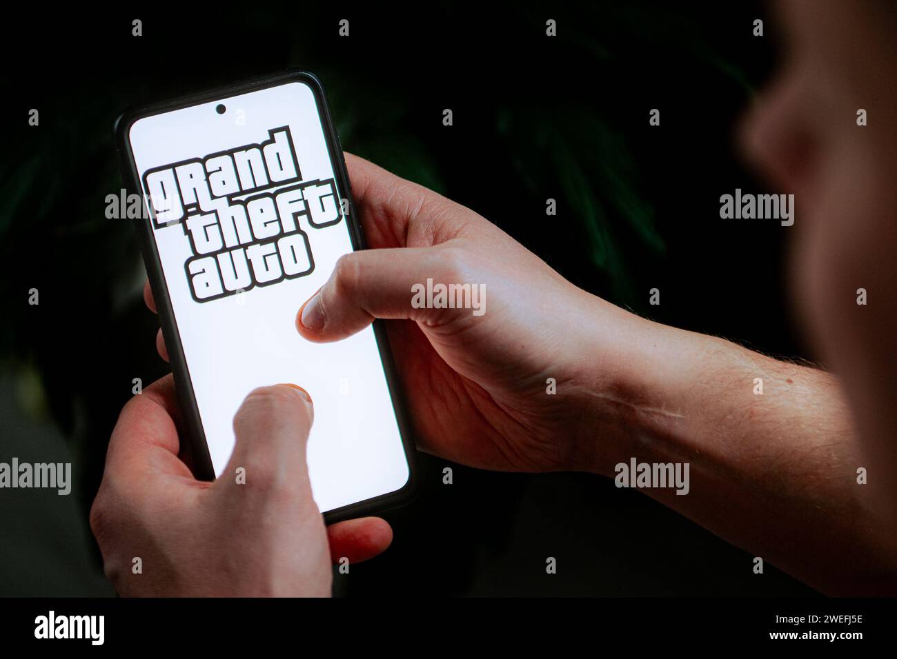 In this photo illustration a Grand Theft Auto logo seen displayed on a ...