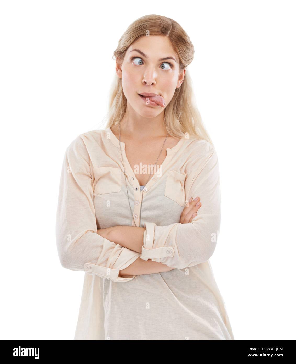 Funny face, tongue and squint with woman arms crossed in studio ...