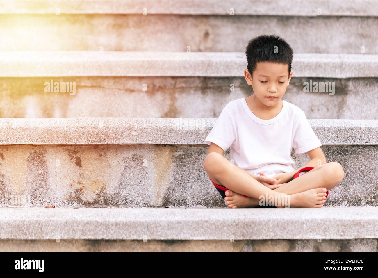 Asian kid meditating in the park. Cute little boy in meditation pose ...