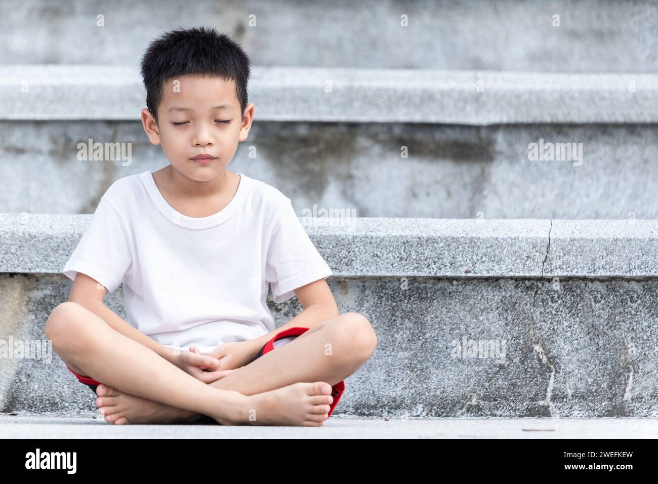 Asian kid meditating in the park. Cute little boy in meditation pose ...