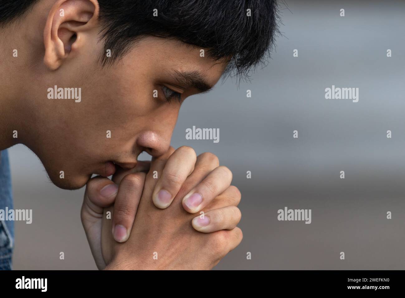 A man praying and close your eyes in praying. Prayer to pray. A young ...