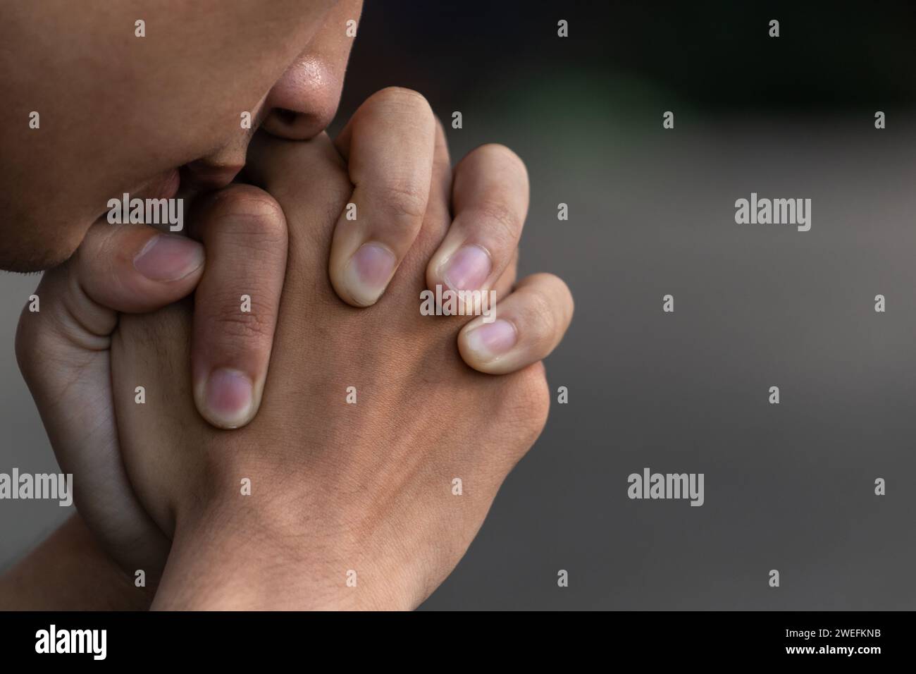 A man praying and close your eyes in praying. Prayer to pray. A young ...