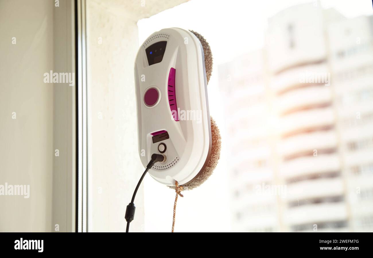 A modern device, a vacuum robot window cleaner, cleans glass from dirt ...
