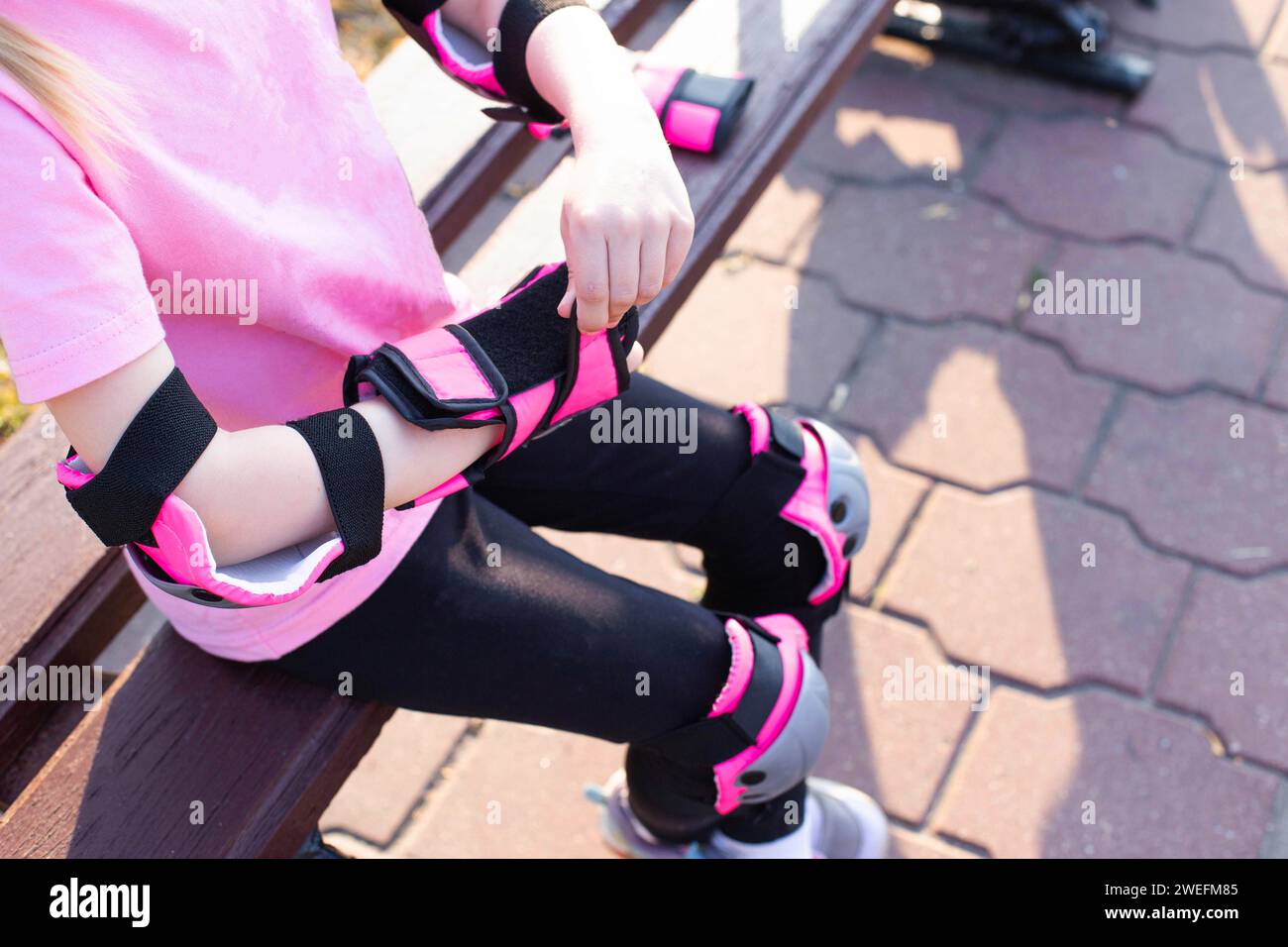 Protective pink oversleeves in the girl's arms. The concept of ...