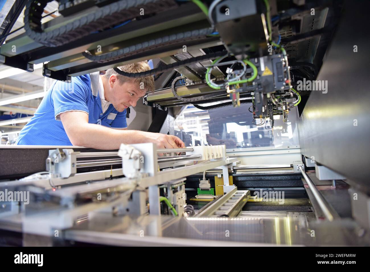 engineer working on a machine for assembly and production of ...