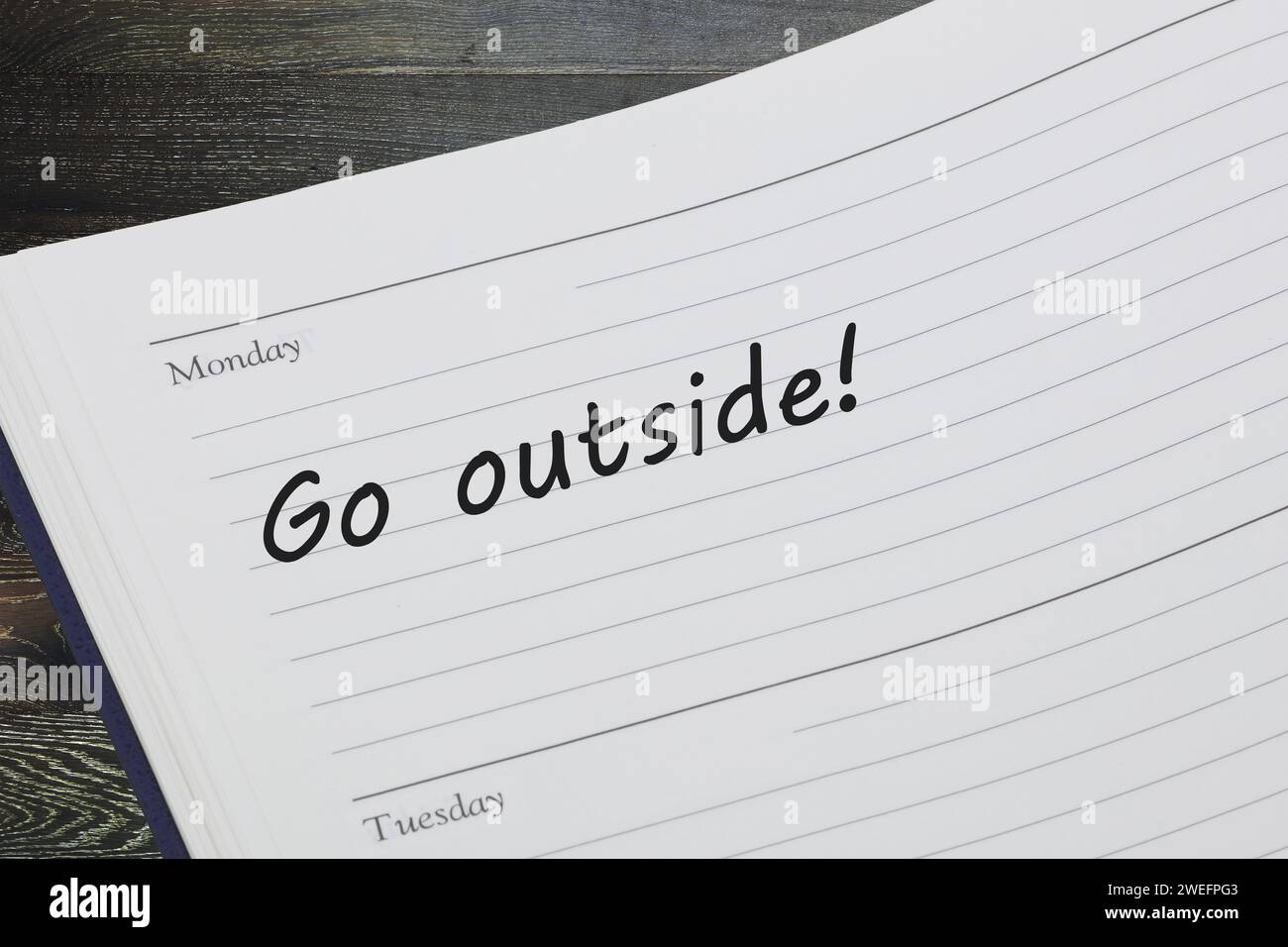 Go outside reminder message in an open diary Stock Photo - Alamy