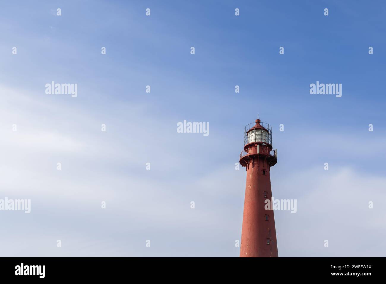 Soaring into the clear sky, the red Andenes Lighthouse on Norway's ...