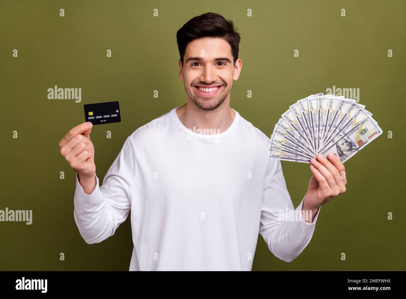 Portrait of young guy finally received his fist official paid salary on ...
