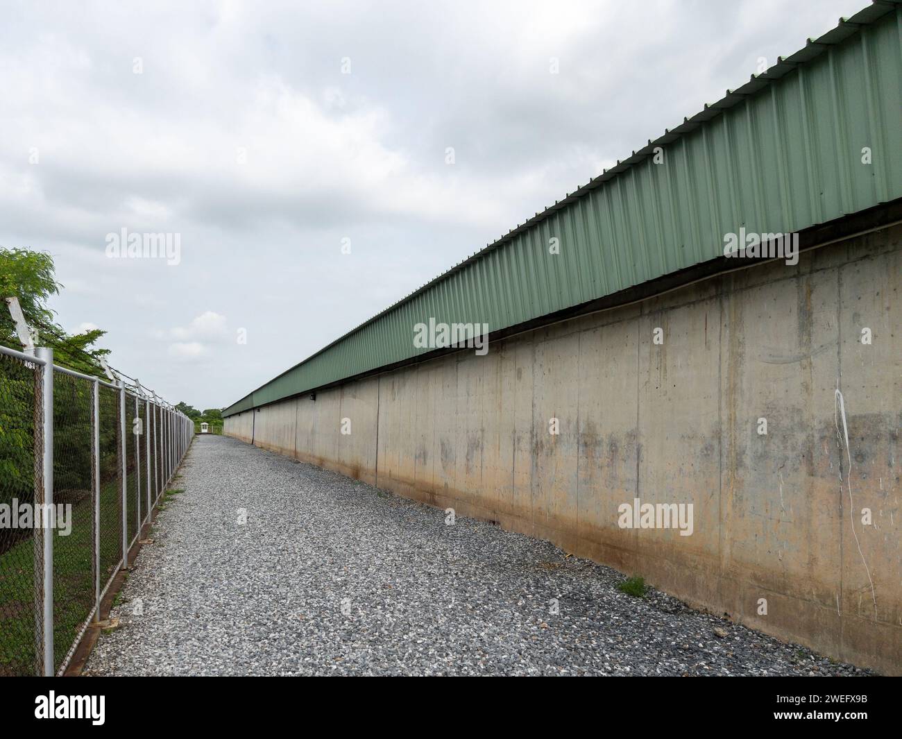 The barbed wire fence surrounds the water storage building for ...