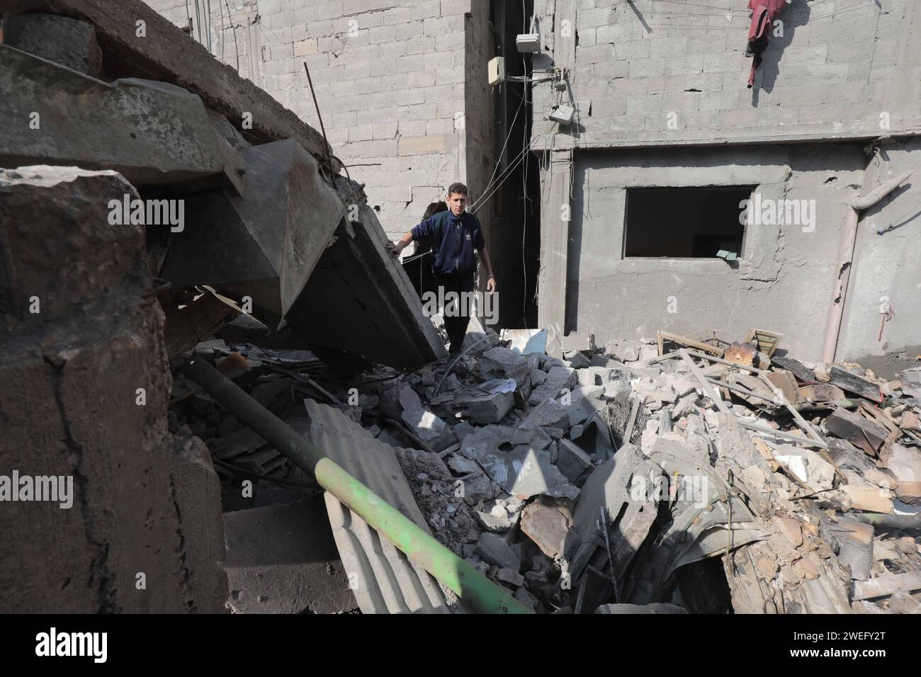 Palestinians inspect destruction after an Israeli bombing of building ...