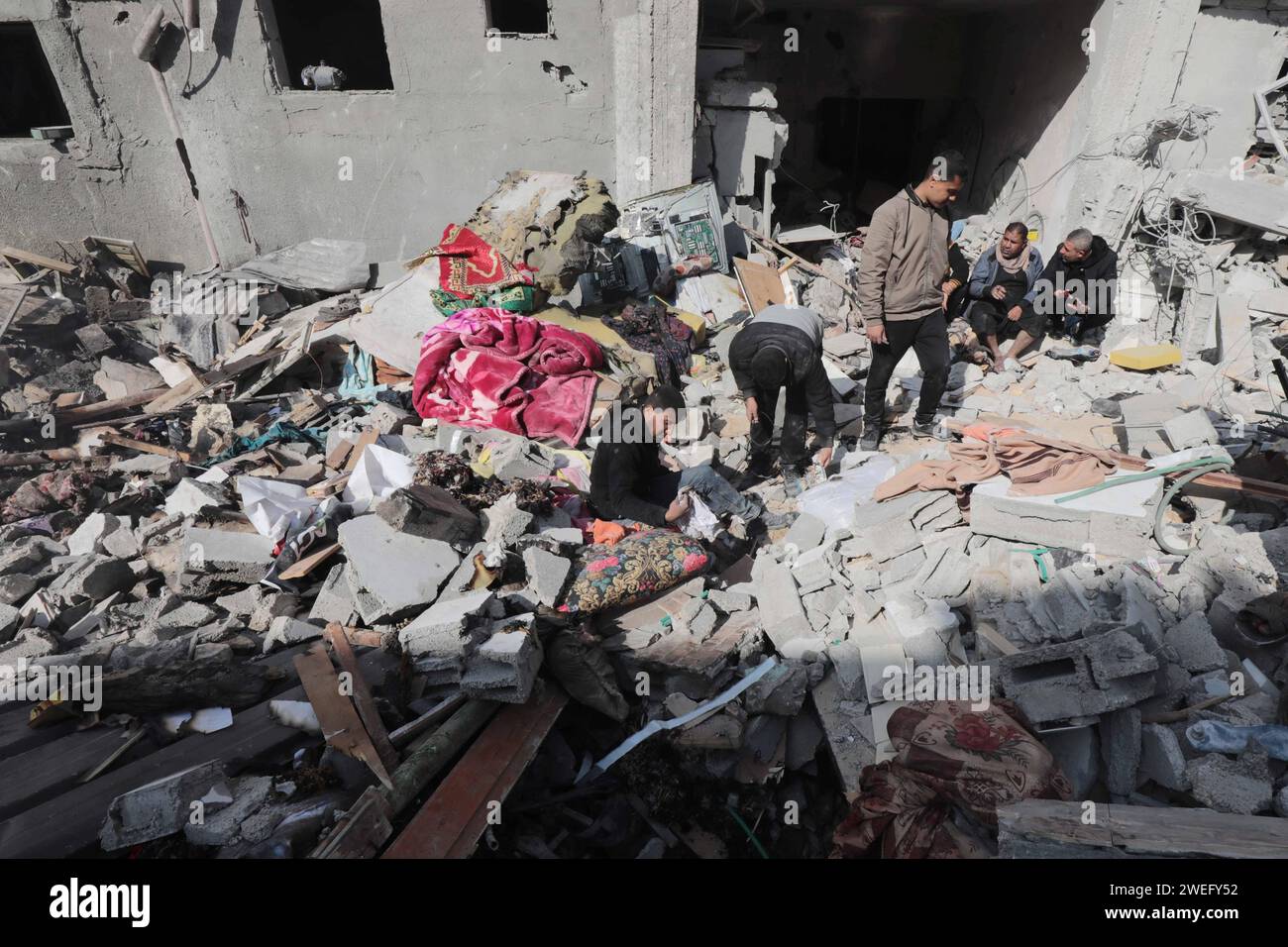 Palestinians inspect destruction after an Israeli bombing of building ...