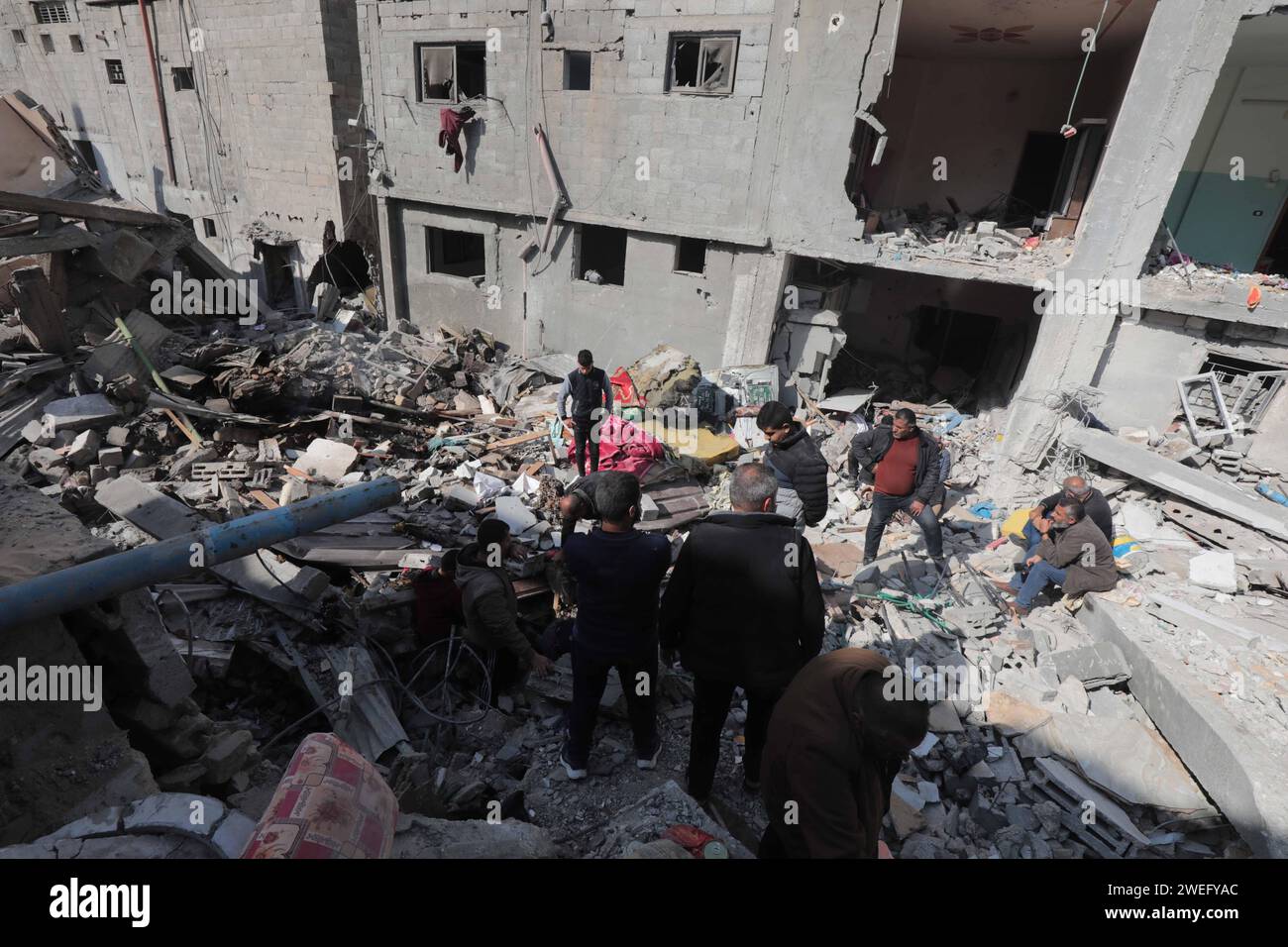 Palestinians inspect destruction after an Israeli bombing of building ...