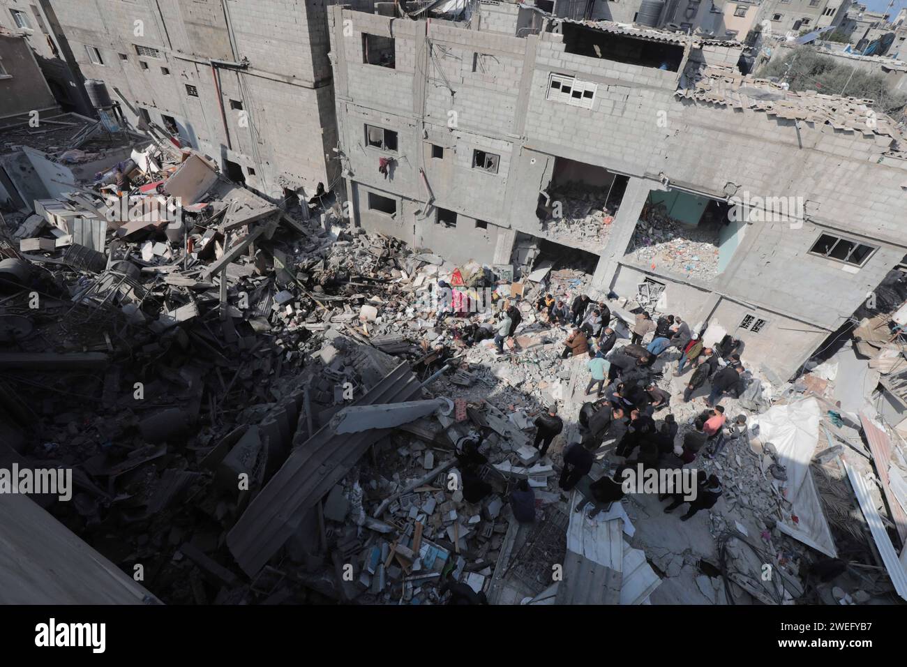 Palestinians inspect destruction after an Israeli bombing of building ...