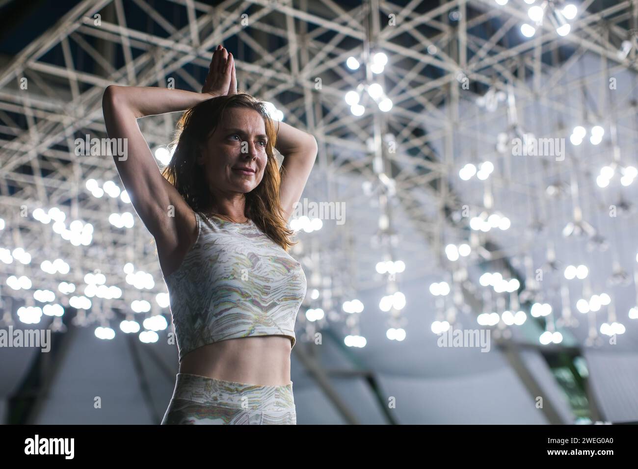 yoga meditation pose under light bulbs Stock Photo - Alamy