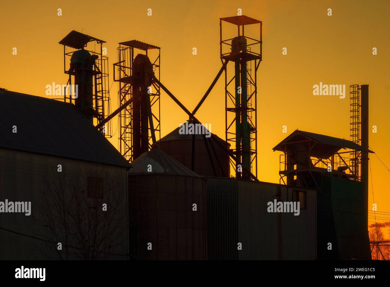 Silhouette of small factory against sky at dawn. Factory small business ...