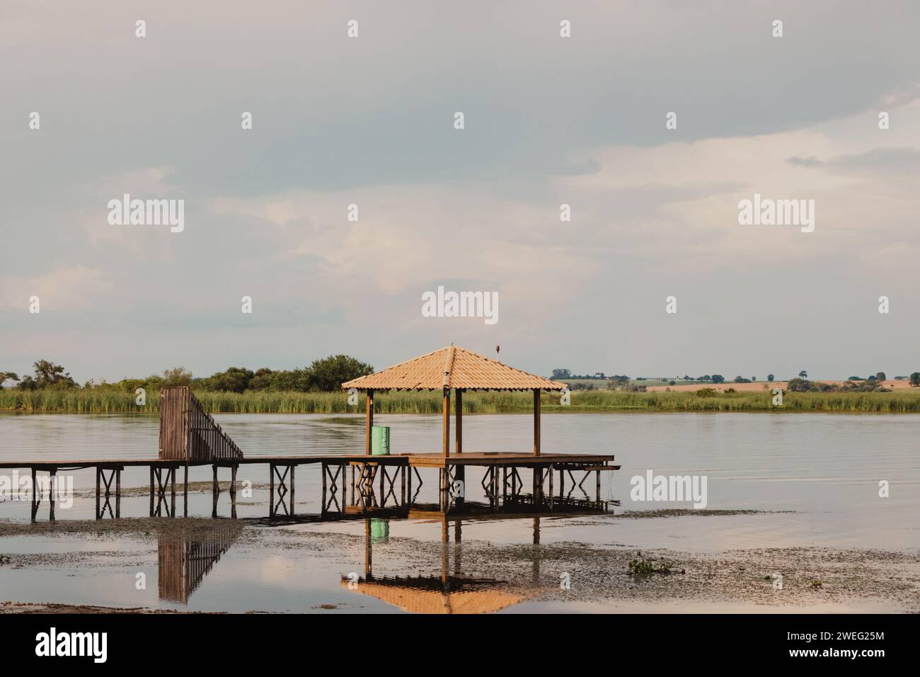 landscape of pier in the lagoon at sunset Stock Photo - Alamy