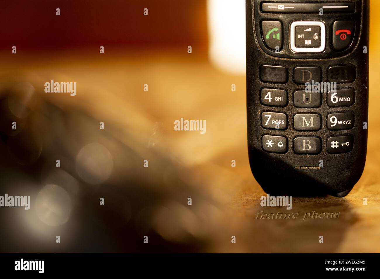 concept of feature and dumb phone with the keyboard of an ol phone ...