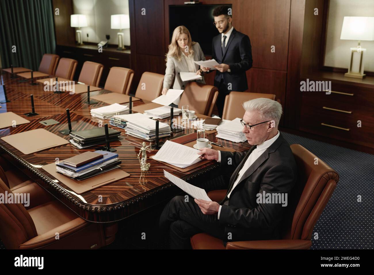 Group of biracial attorneys doing paperwork side by side in classic ...