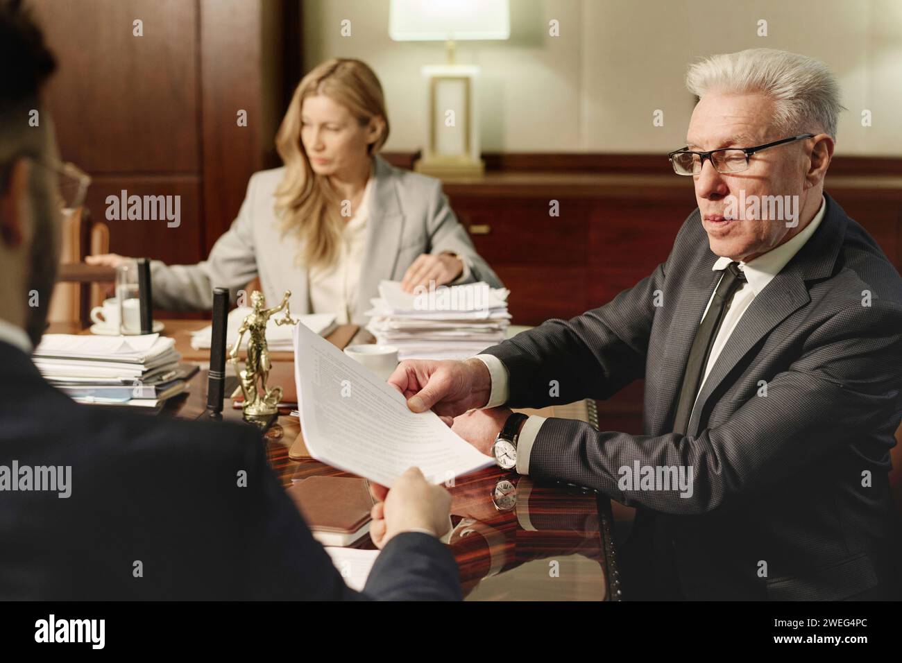 Caucasian woman giving document biracial hi-res stock photography and ...