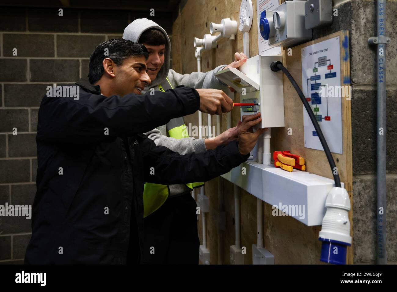 Prime Minister Rishi Sunak does some electrical work with a trainee ...