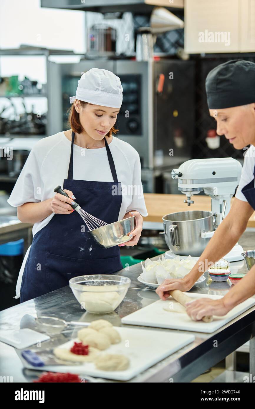 beautiful female chefs in blue toques and aprons working on their dough ...