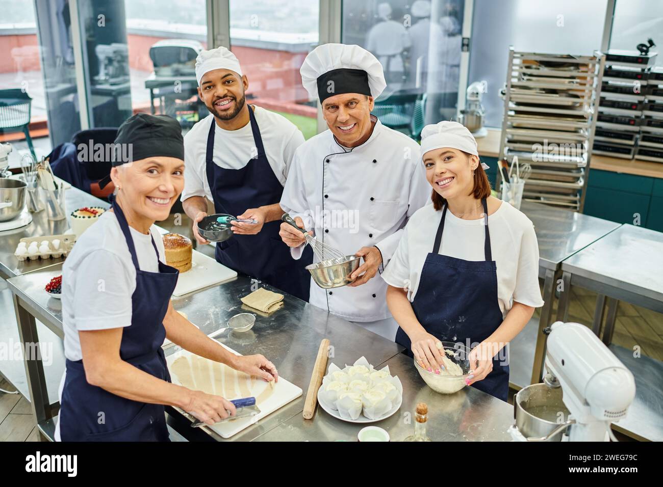 good looking cheerful diverse team of chefs posing with their chief ...