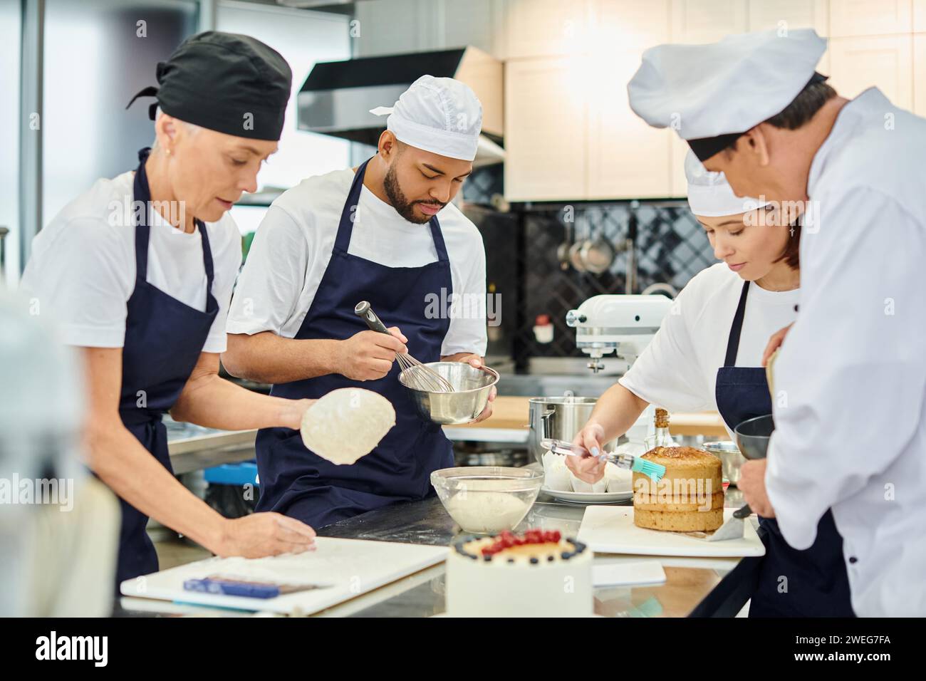 hard working multicultural chefs and chief cook working pasty together ...