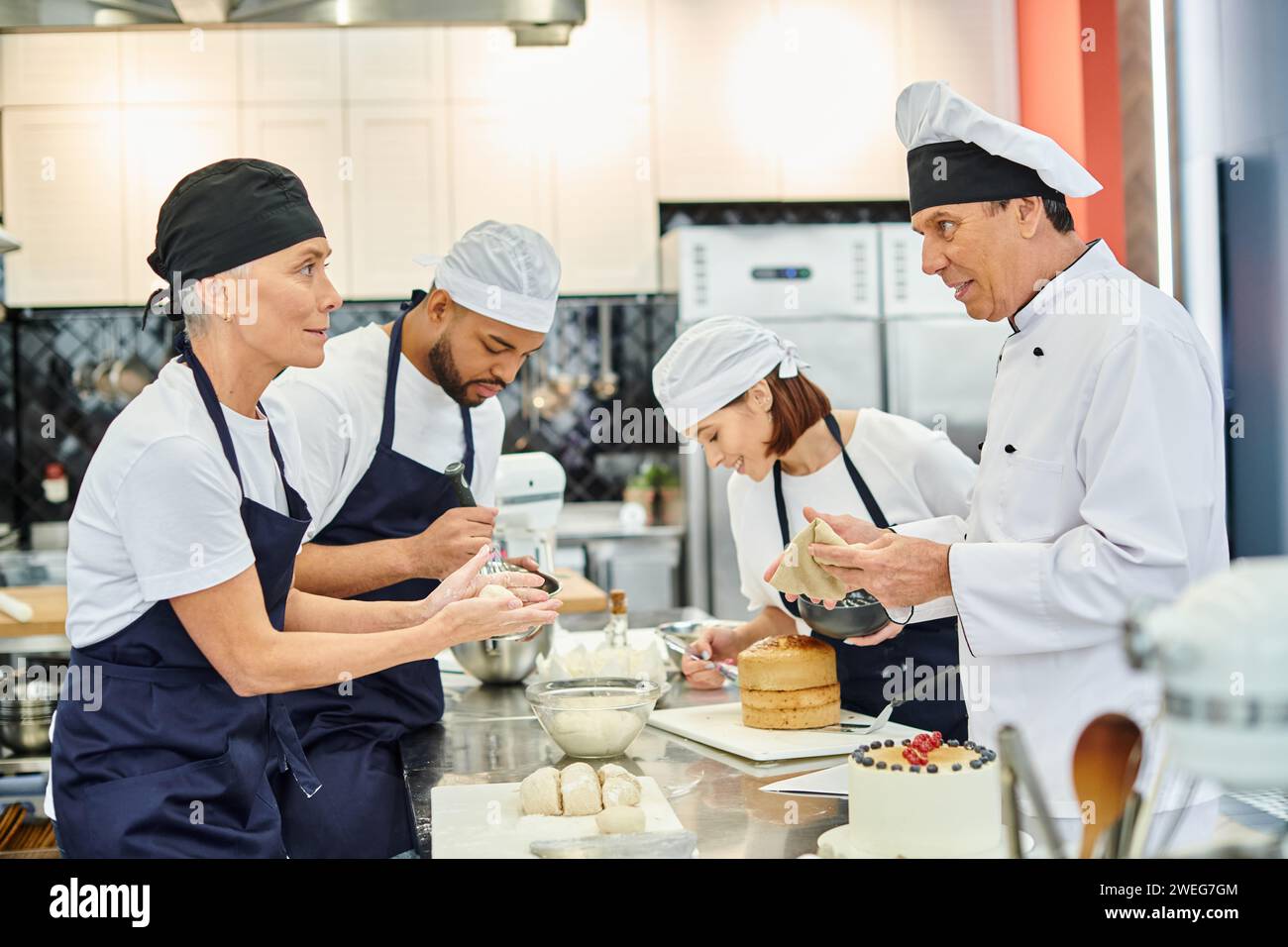 jolly mature chief cook and female chef talking and their diverse ...