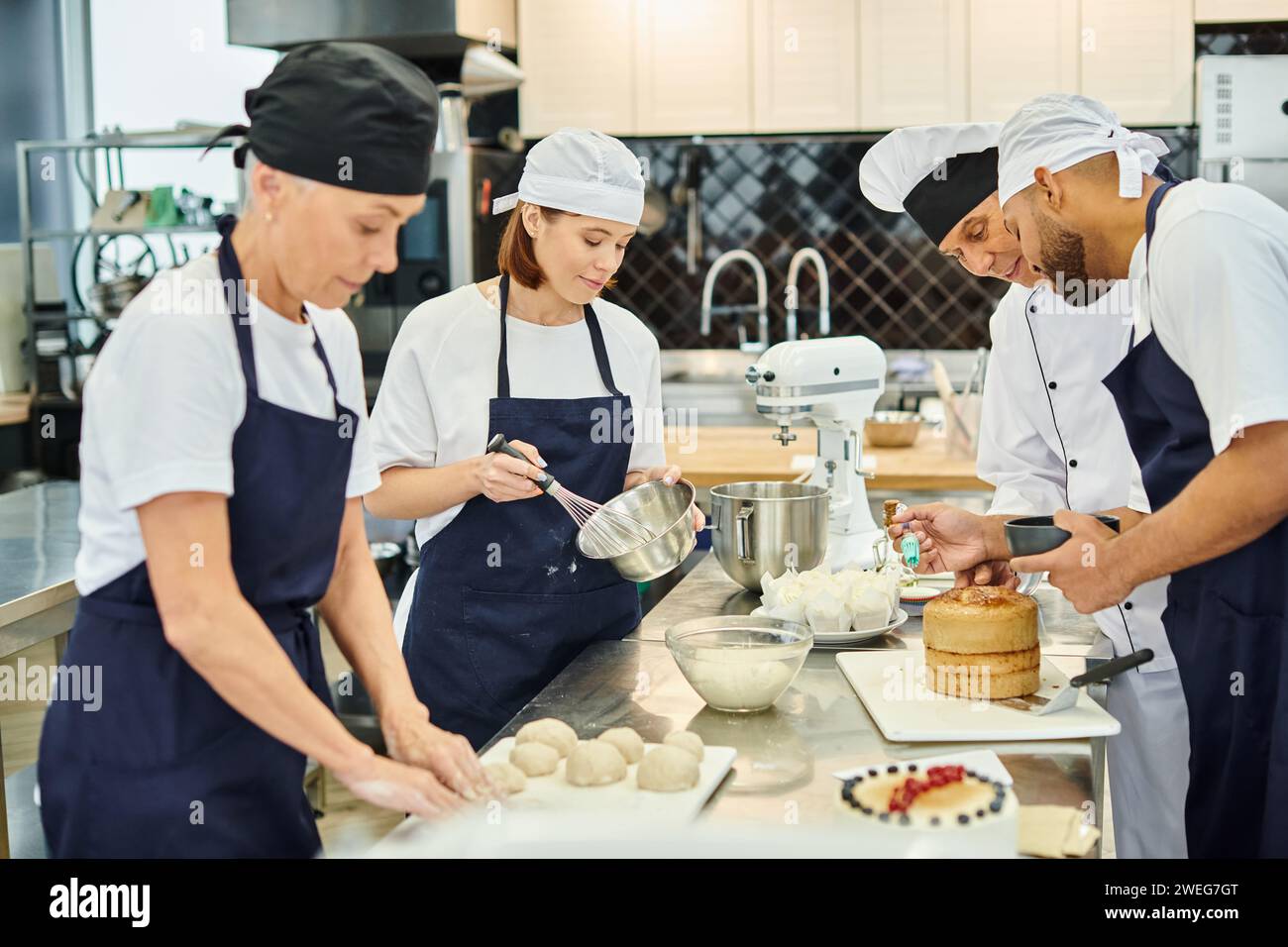 joyous multiracial team of chefs with their chief cook working on ...