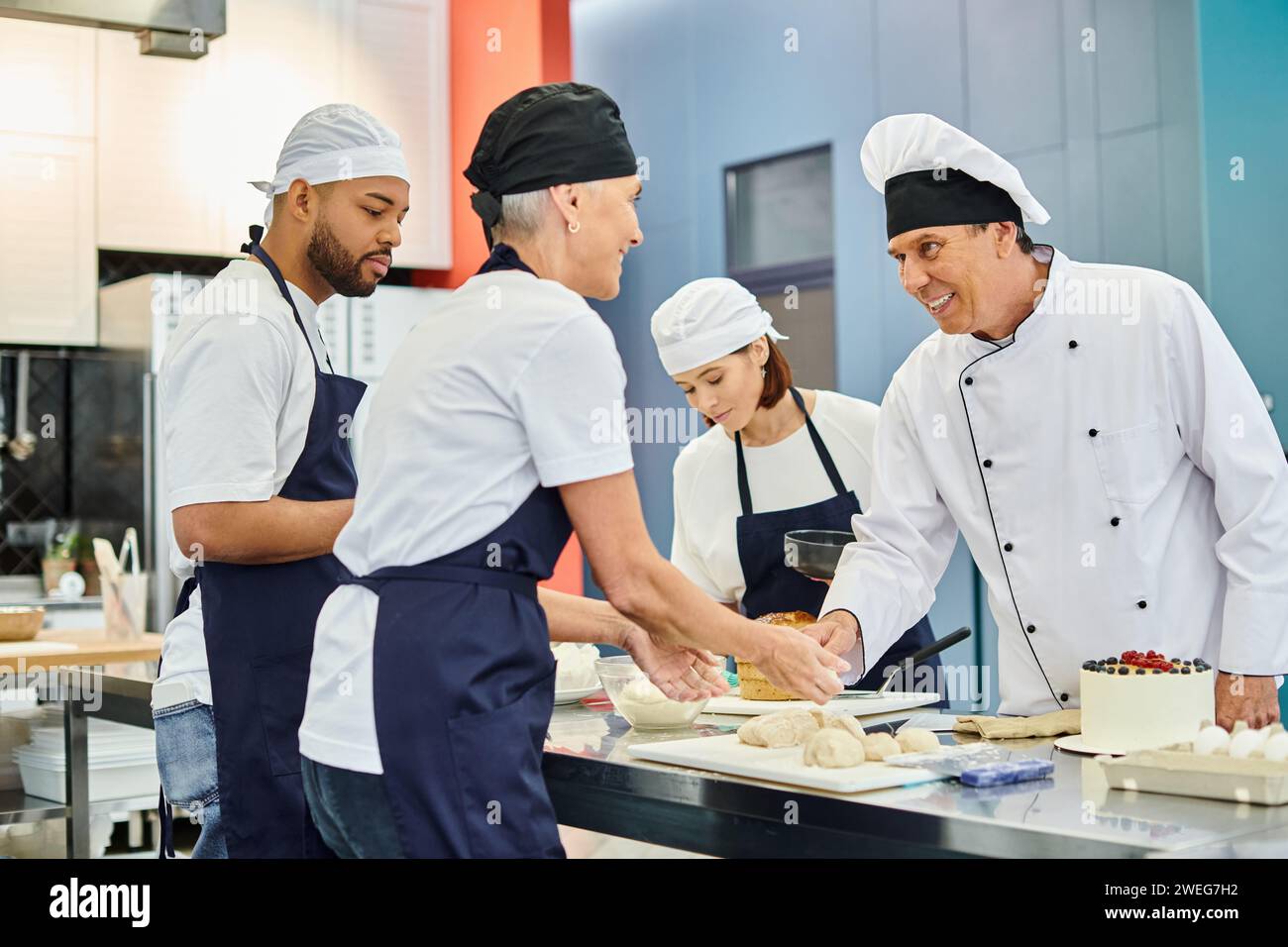 happy mature chief cook and chef smiling while their interracial ...