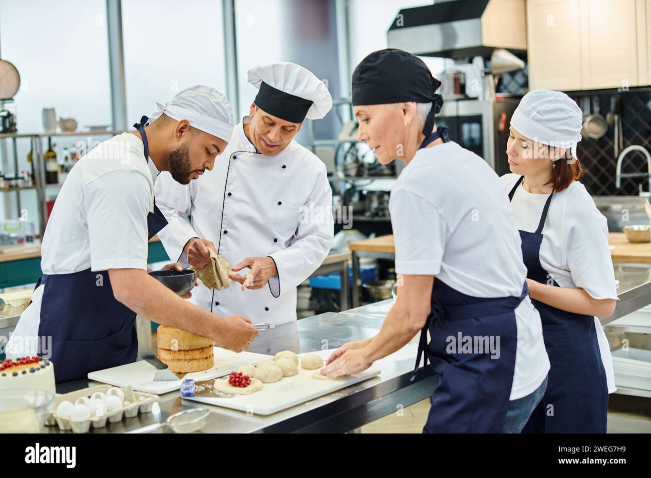 multiracial chefs with their chief cook in white hat baking together on ...