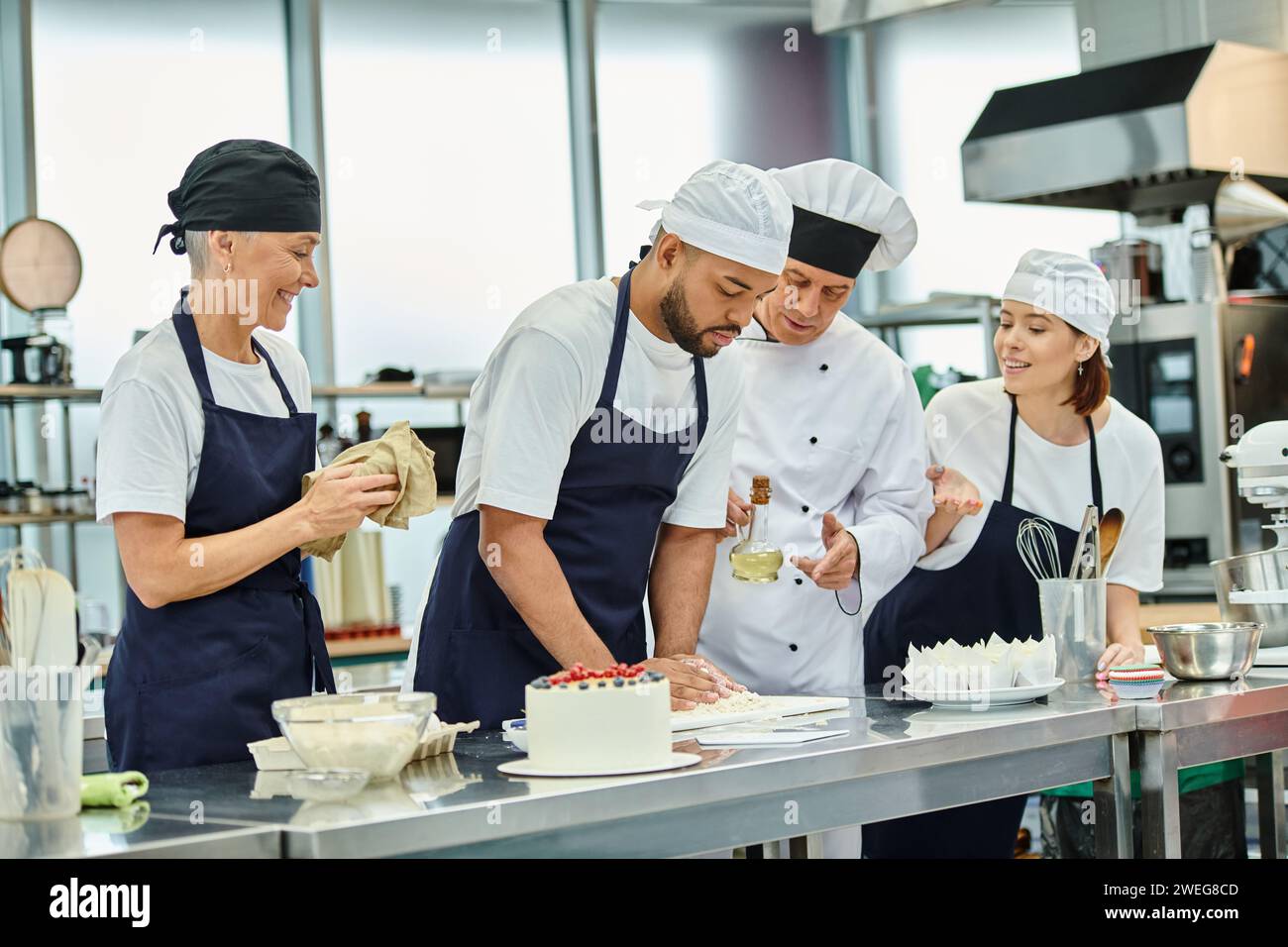 cheerful female chefs and chief cook watching their african american ...