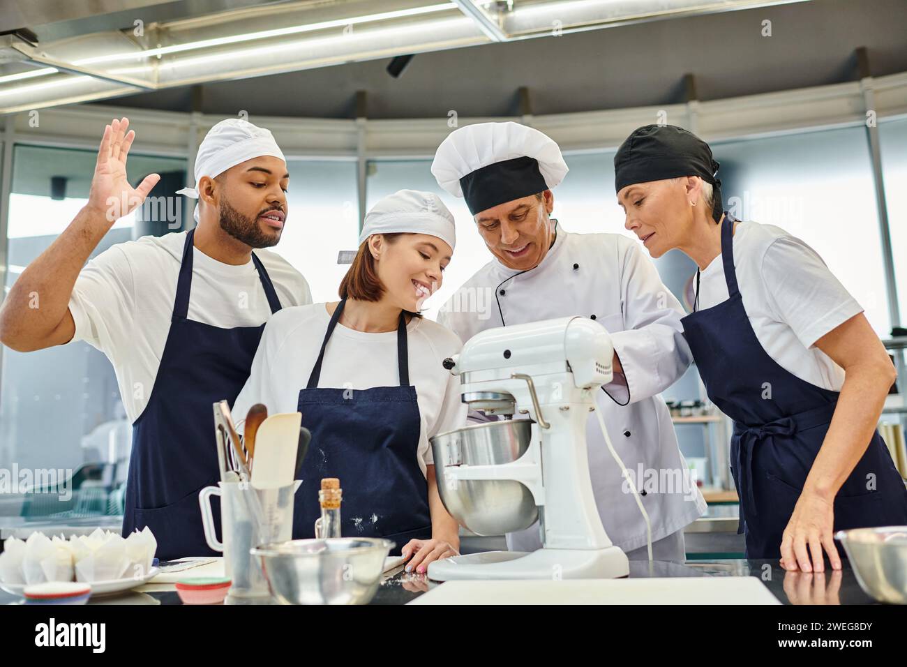 jolly multicultural chefs watching their chief cook showing them how to ...